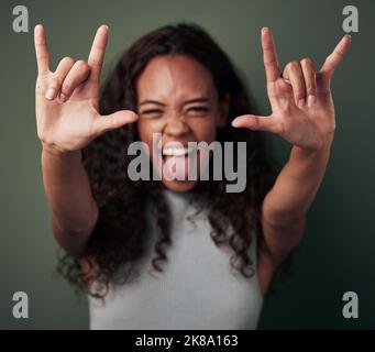 Beautiful african woman making rock symbol with hands, shouting and ...