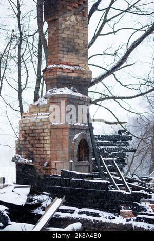 Ruins of a house after a fire with a surviving brick oven. The ruins ...