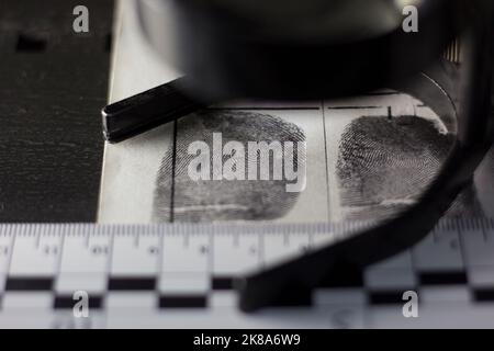 Lens, fingerprints and forensic ruler on fingerprint card Stock Photo ...