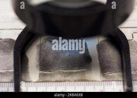 Lens, fingerprints and forensic ruler on fingerprint card Stock Photo ...