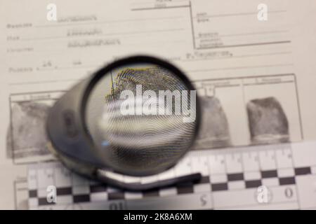 Lens, fingerprints and forensic ruler on fingerprint card Stock Photo ...