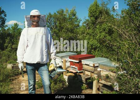 Portrait of a Turkish Beekeeper posing with a frame of honeycomb and ...