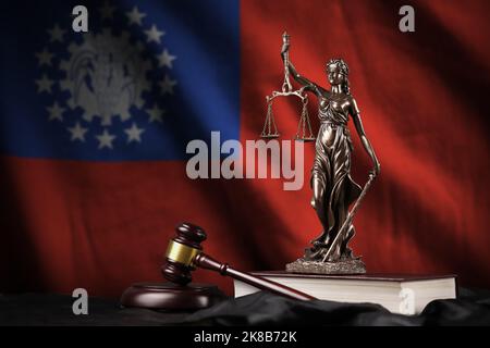 Myanmar flag with statue of lady justice and judicial scales in dark ...