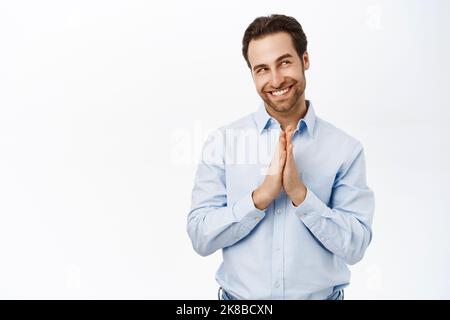 Handsome pleased businessman, rub hands and smiling devious, having ...