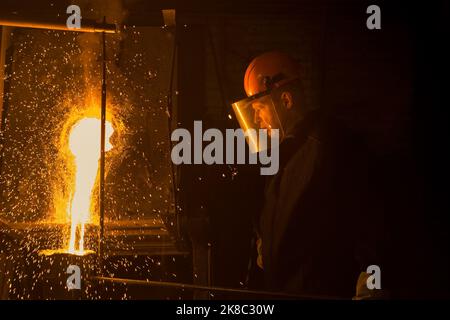 smelter worker pours liquid metal into a casting mold Stock Photo - Alamy