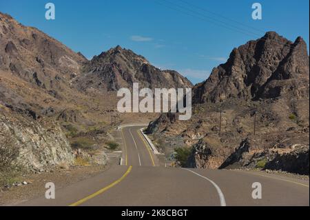 Scenic drive through a long, sloping road in Hatta, rocky Al-Hajar ...