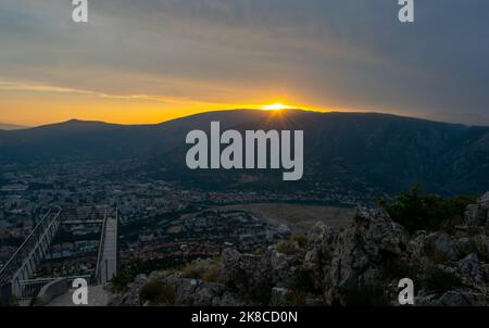 Fantastic sunset above the city of Mostar and romantic skywalk platform ...