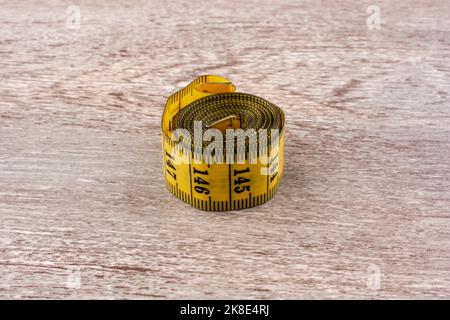 Yellow color Tape measure roll on a grey background Stock Photo - Alamy
