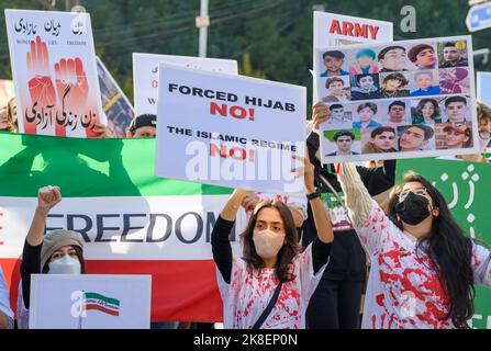 Iranians hold placards expressing their opinion during the ...