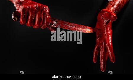 A faceless man cuts his hand covered in blood. Black background Stock ...