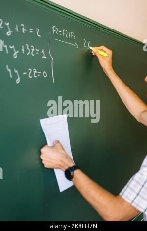 Hand writing a math problem on board with a chalk Stock Photo - Alamy