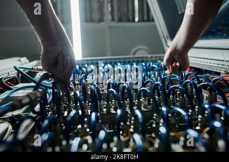 Hand of a man holding The network cables to connect the port of a ...