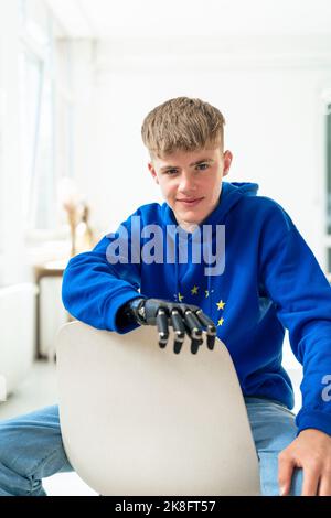 Boy with amputated arm sitting on footpath Stock Photo - Alamy