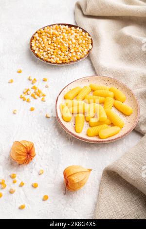 Jelly corn candies on gray concrete background and linen textile. top ...