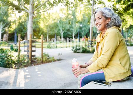 Senior sportswoman looking at her smartphone Stock Photo - Alamy