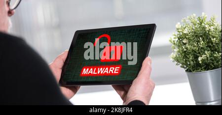 Tablet screen displaying a malware concept Stock Photo - Alamy