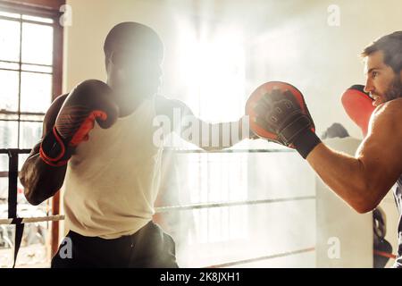 Black man, boxing and personal trainer in self defense or ring fight at ...