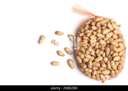A top view of peanuts stored in a mesh bag cut out on a white ...