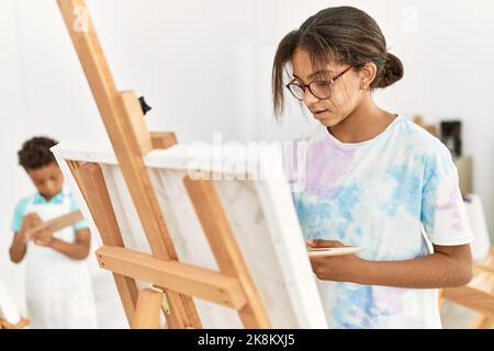 Brother and sister concentrate drawing at art studio Stock Photo - Alamy