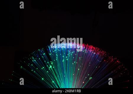 A closeup shot of a color-changing fibre optic lamp in the darkness ...