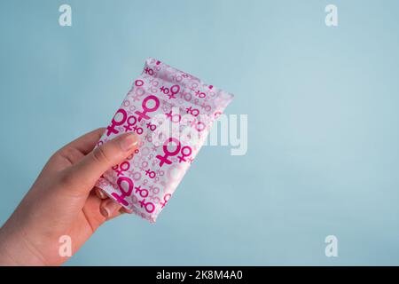 A women's hygiene pad and pink women's symbol on the package Stock ...