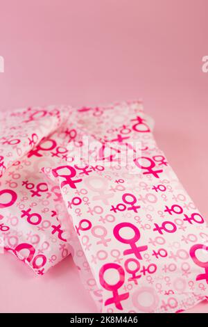 A women's hygiene pad and pink women's symbol on the package Stock ...