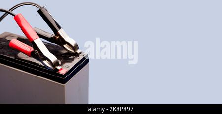 connected bolts charging positive pole and negative pole of battery ...