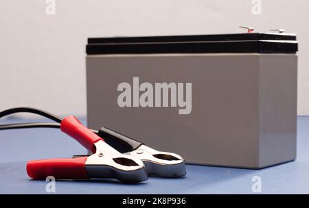 connected bolts charging positive pole and negative pole of battery ...