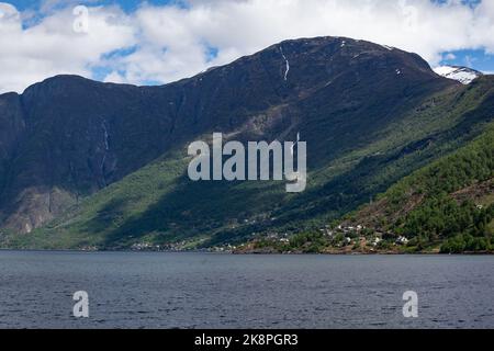 A Narrow Fjord surrounded by mountains covered with trees in Vestland ...