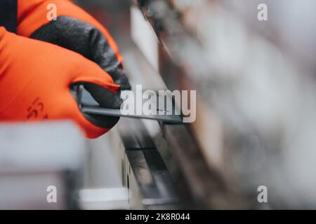 A factory worker making metal details, close-up Stock Photo - Alamy