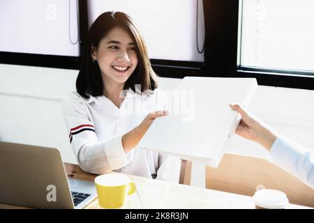 Two female company employees happily smiled at each other as they ...