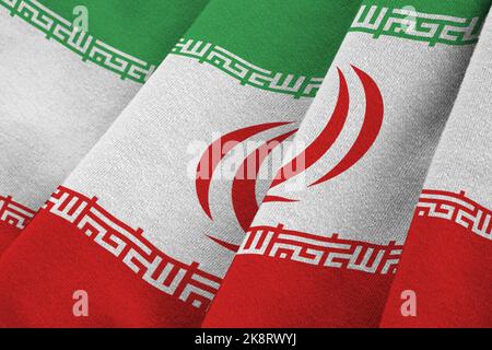 Iran flag with big folds waving close up under the studio light indoors ...