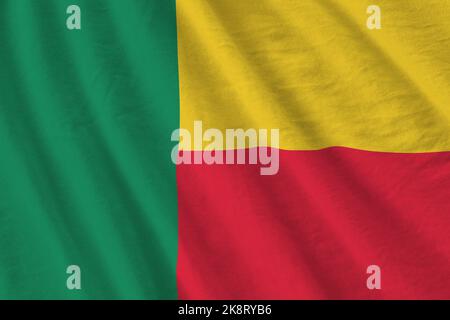 Benin flag with big folds waving close up under the studio light ...