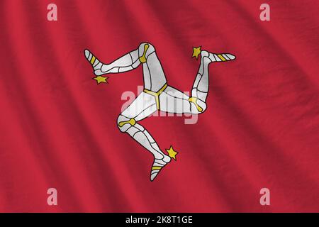 Isle of Man flag with big folds waving close up under the studio light ...