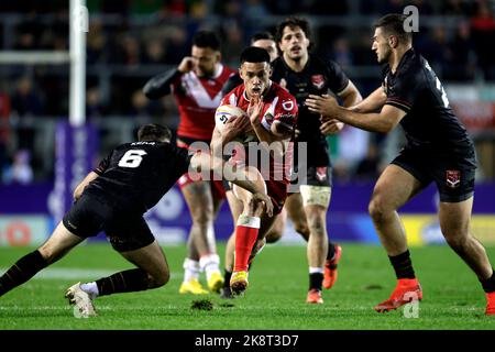 Soni Luke of Tonga is tackled by Elliot Kear of Wales during the Rugby ...