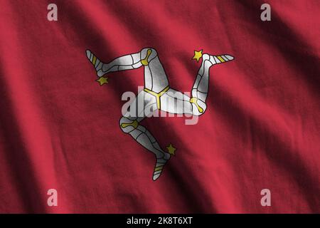 Isle of Man flag with big folds waving close up under the studio light ...