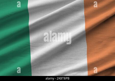 Ireland flag with big folds waving close up under the studio light ...