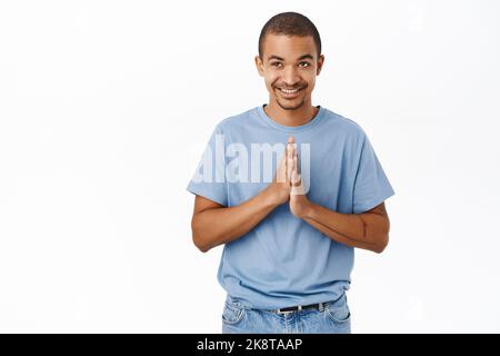 Arab man with beard standing over bricks wall background with hand on ...