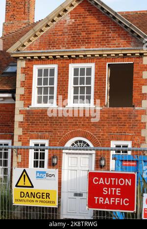Luxury Red House with missing window, behind fence, property being ...