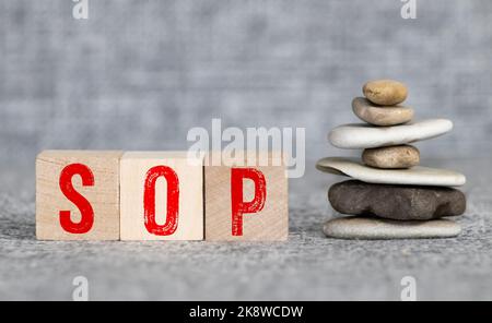 SOP - acronym from wooden blocks with letters, abbreviation SOP ...