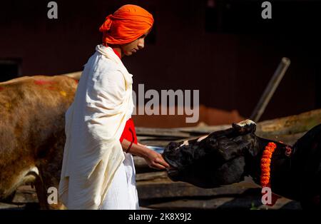 Kathmandu, Nepal. 25th Oct, 2022. A devotee ties a sacred thread on the ...