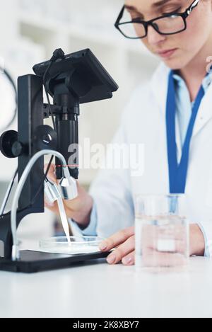 Doing a bit of research. a young female university student reading in a ...