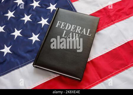Law concept. On the US flag lies a pen and a book with the inscription ...