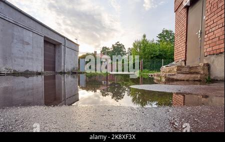A Giant puddle in the yard Stock Photo - Alamy