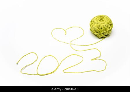 heart and number 2023 made of green yarn and ball of yarn isolated on ...