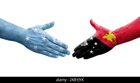Handshake between Micronesia and Guinea flags painted on hands ...