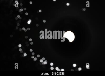 Aitrang, Germany. 25th Oct, 2022. Partially covered by the moon is the ...