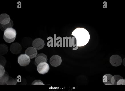 Aitrang, Germany. 25th Oct, 2022. Partially covered by the moon is the ...