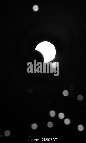 Aitrang, Germany. 25th Oct, 2022. Partially covered by the moon is the ...