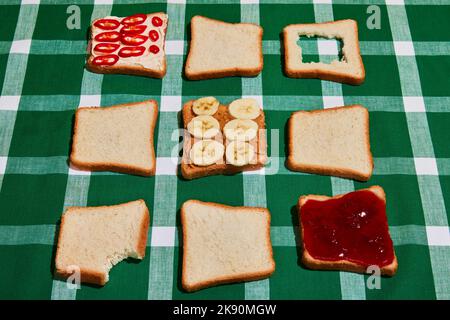 Original composition with uncooked bread toasts on plaid green and ...